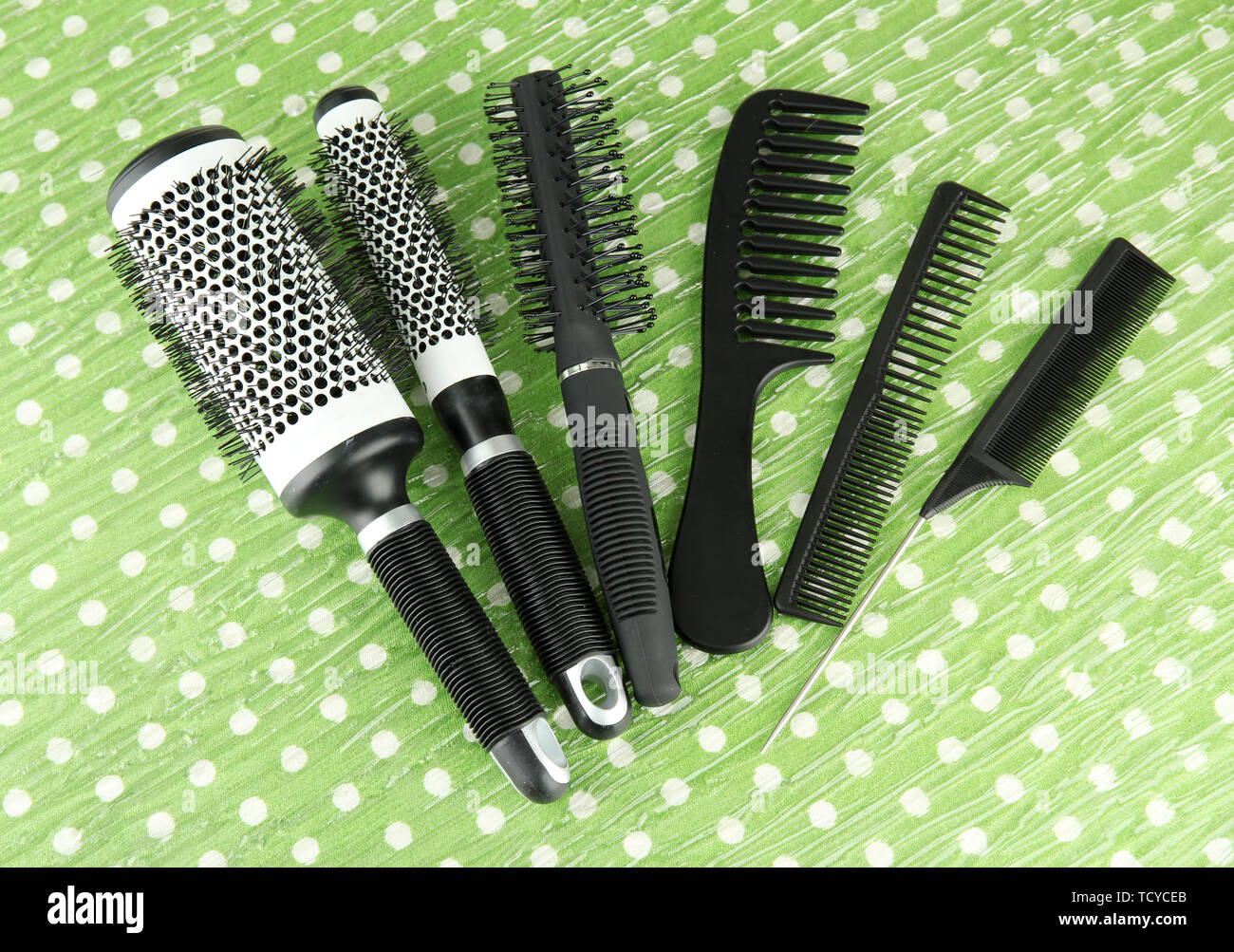 Black combs on color background Stock Photo - Alamy