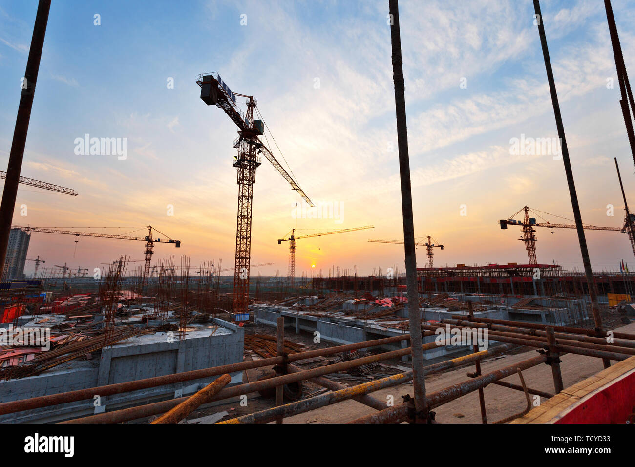 buildings under construction with sunset Stock Photo - Alamy