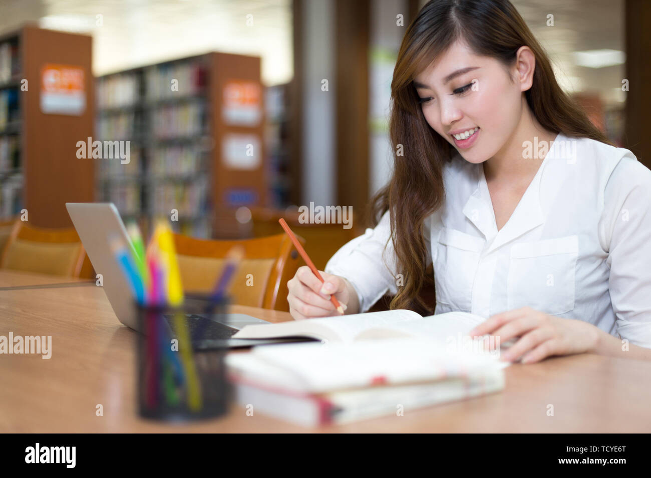 Asian beautiful female student study in library with laptop Stock Photo ...