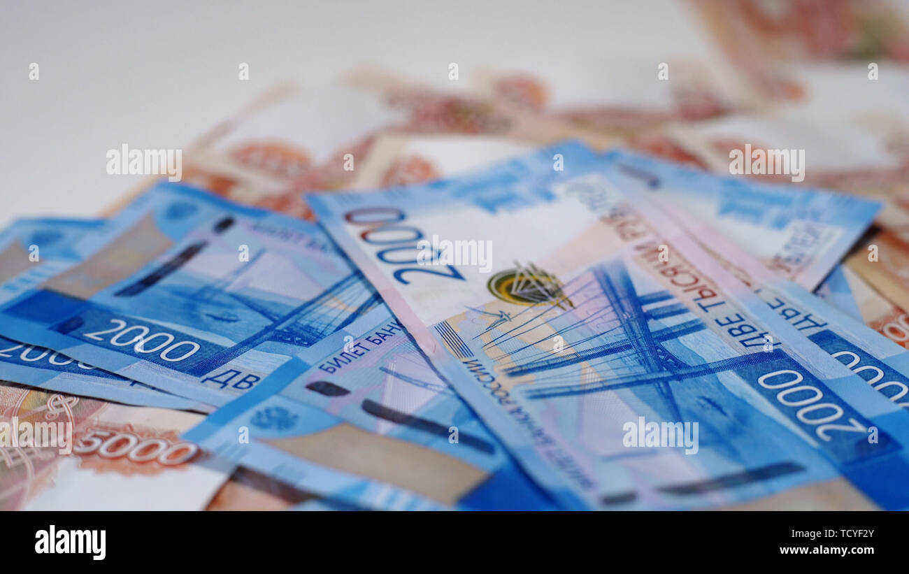 A lot of Russian money, rubles on a white table. Banknotes of 5000 and ...
