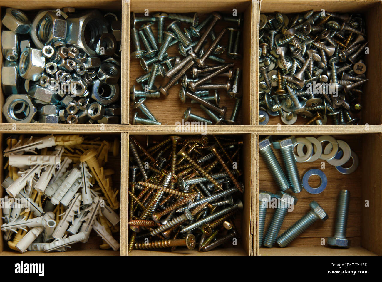 Wooden box for metal bolts, screws and nuts close up Stock Photo - Alamy