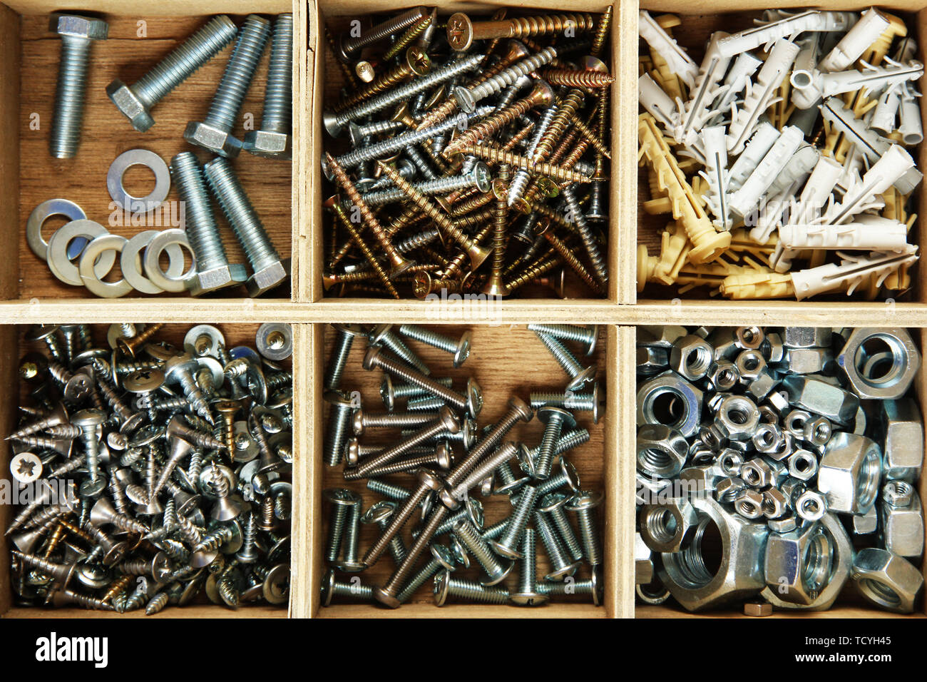 Wooden box for metal bolts, screws and nuts close up Stock Photo - Alamy