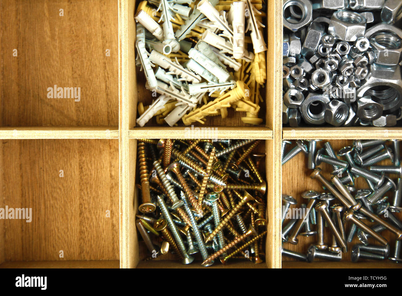 Wooden box for metal bolts, screws and nuts close up Stock Photo - Alamy