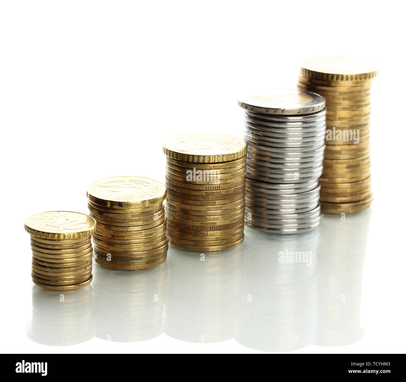 Many coins in columns isolated on white Stock Photo - Alamy