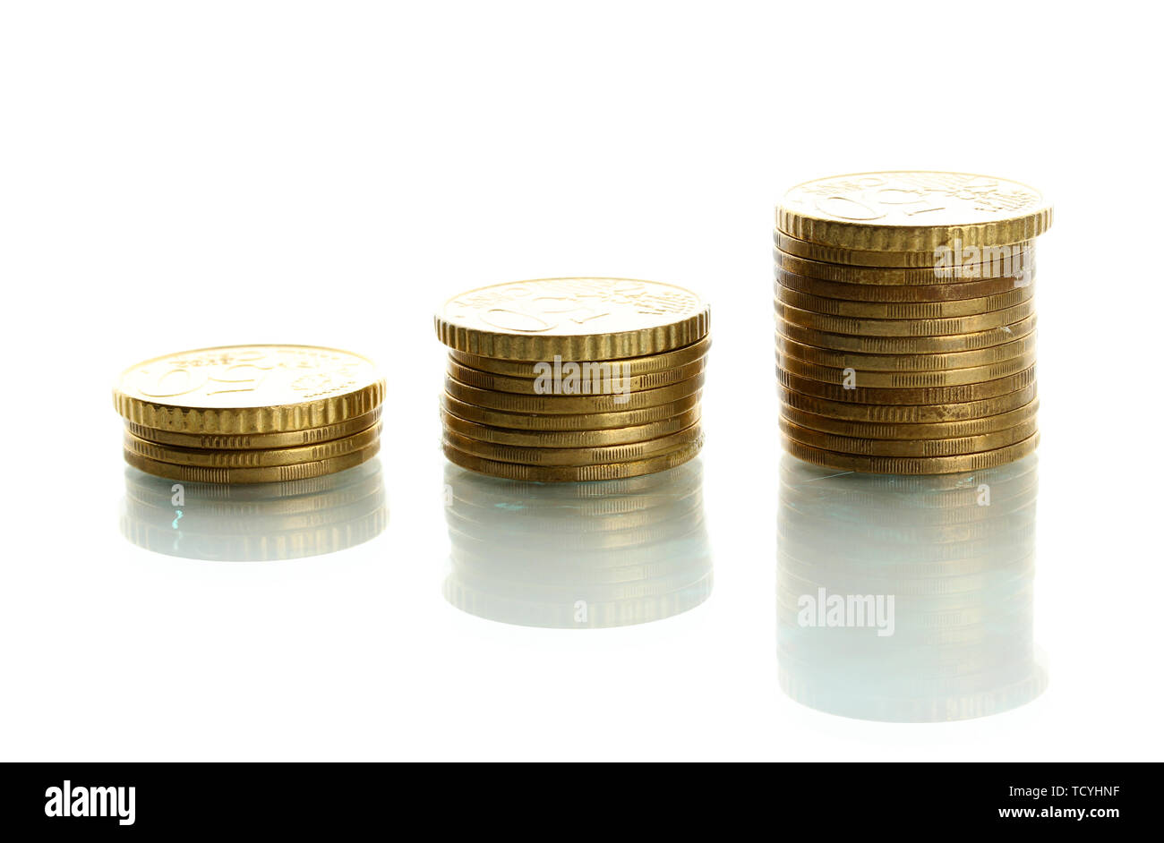 Many coins in columns isolated on white Stock Photo - Alamy