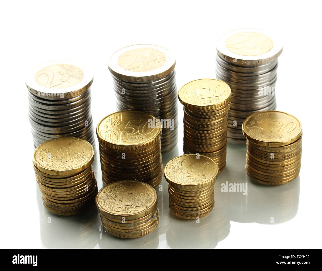 Many coins in columns isolated on white Stock Photo - Alamy