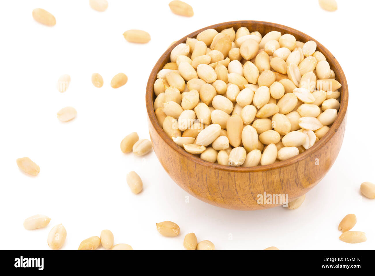 Peeling peanuts on white background Stock Photo - Alamy