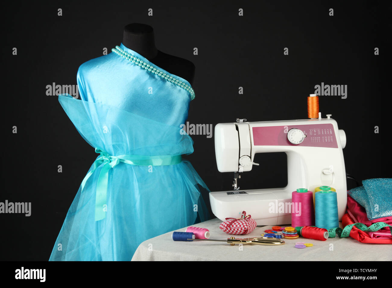 Sewing machine, dummy and other sewing equipment isolated on black ...