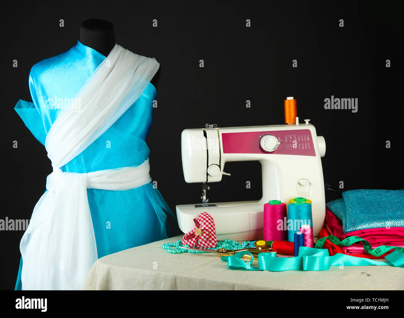 Sewing machine, dummy and other sewing equipment isolated on black ...