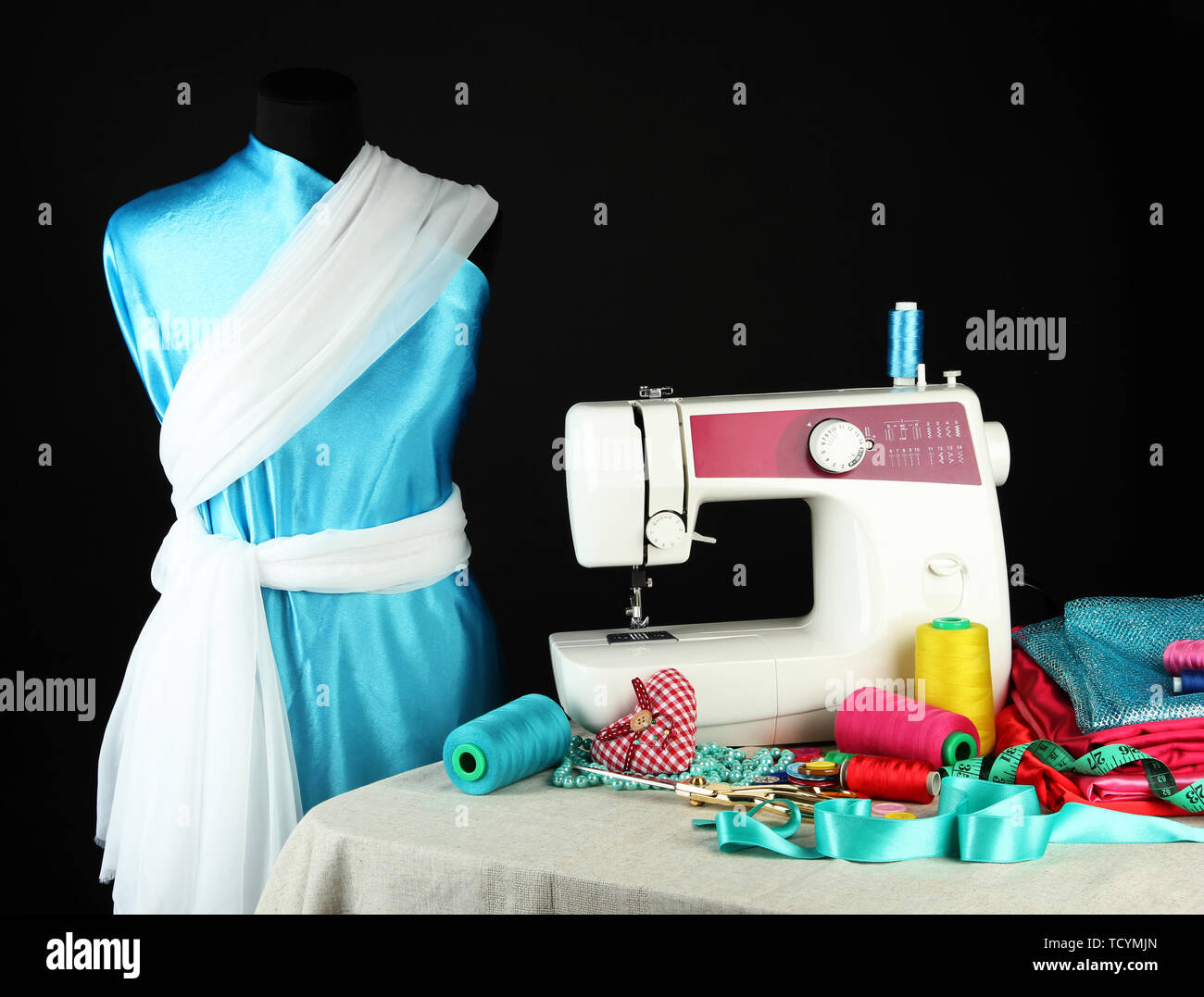 Sewing machine, dummy and other sewing equipment isolated on black ...