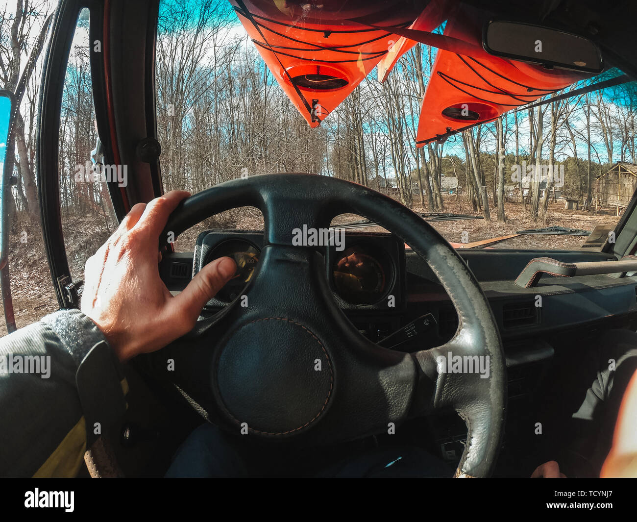 man driving suv car by forest trail road Stock Photo - Alamy