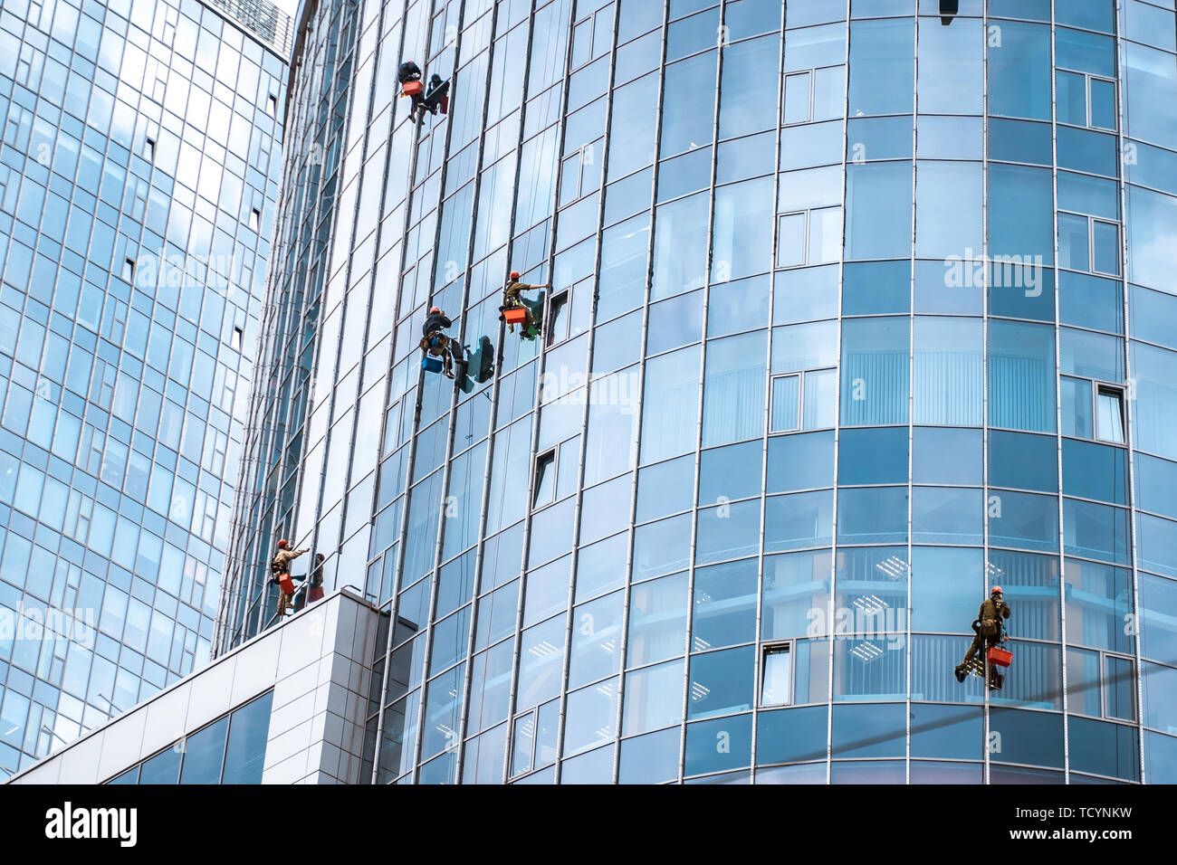 Workers washing windows in the office building Stock Photo - Alamy