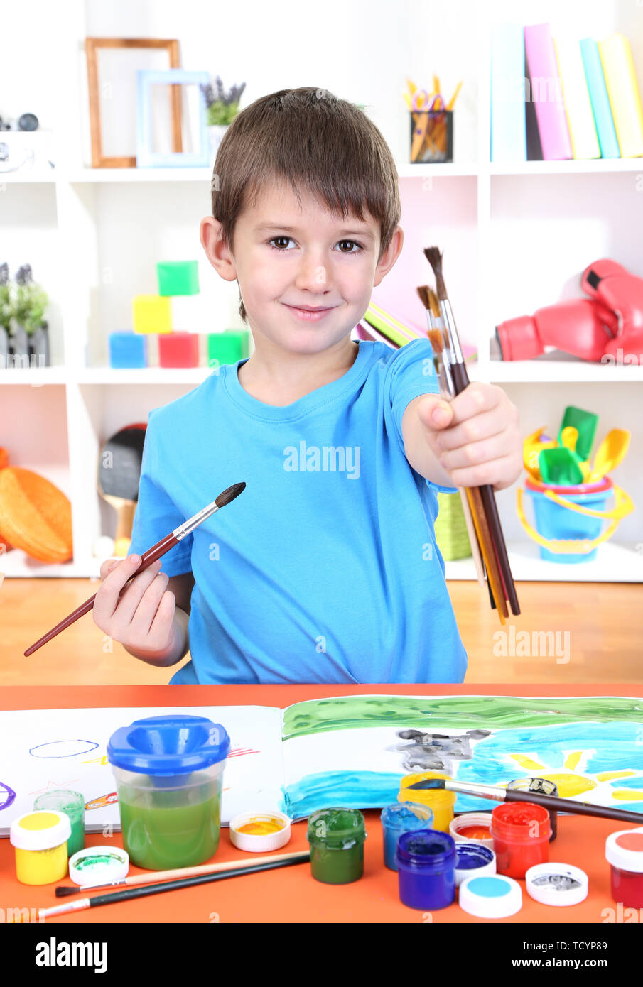 Cute little boy painting in his album Stock Photo - Alamy