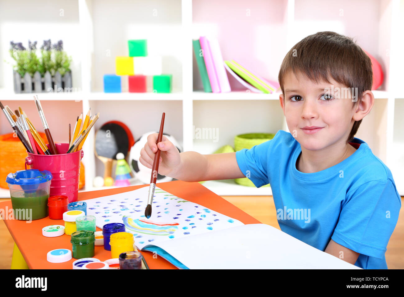 Cute little boy painting in his notebook Stock Photo - Alamy