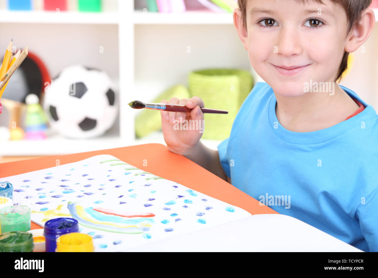 Cute little boy painting in his notebook Stock Photo - Alamy
