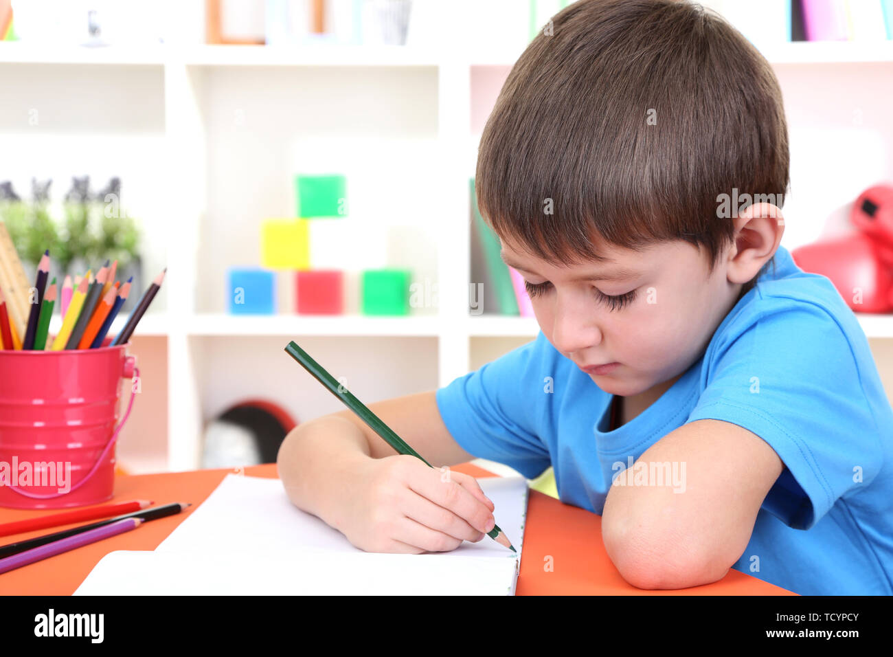 Cute little boy drawing in his album Stock Photo - Alamy