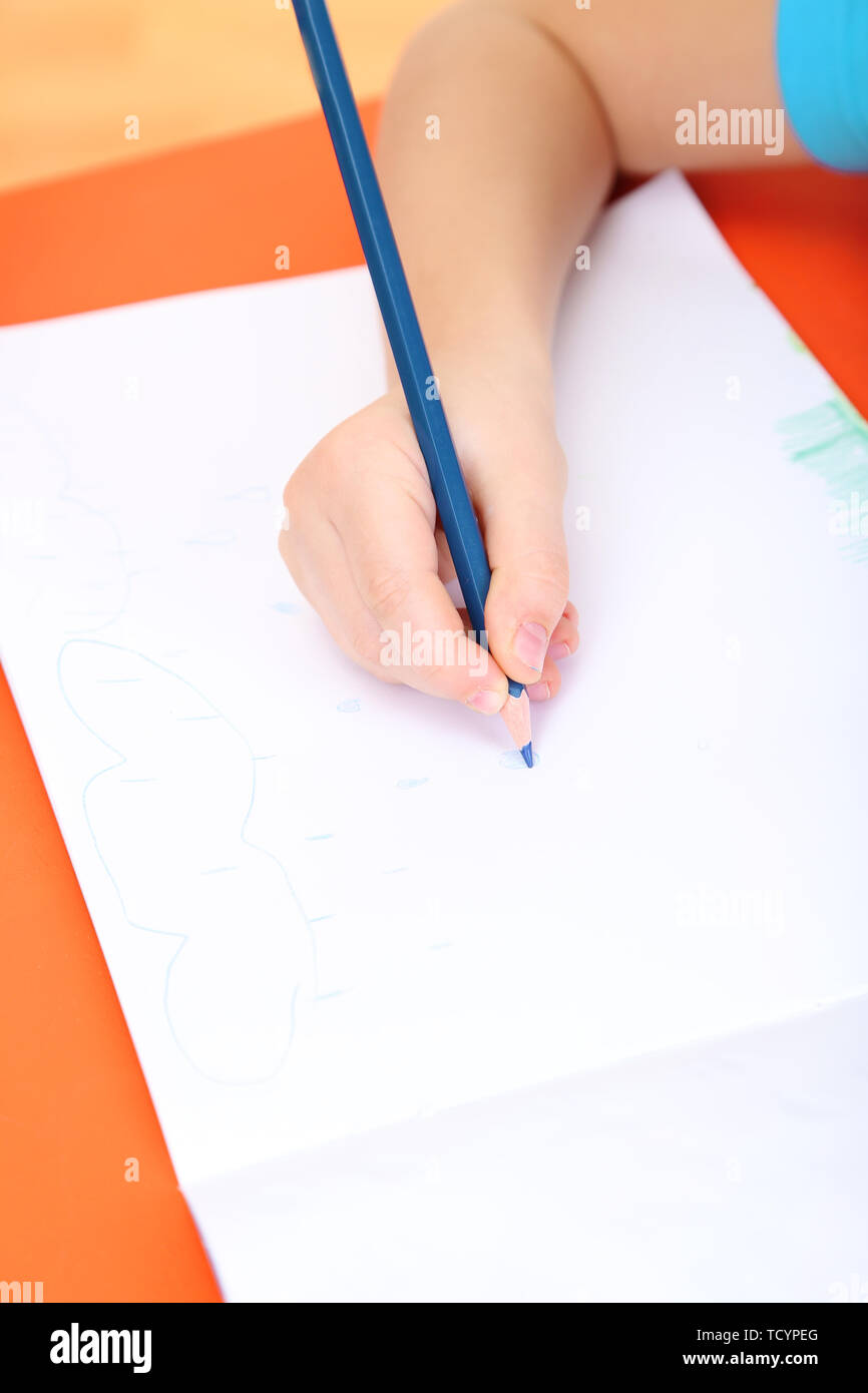 Child drawing in his notebook Stock Photo - Alamy