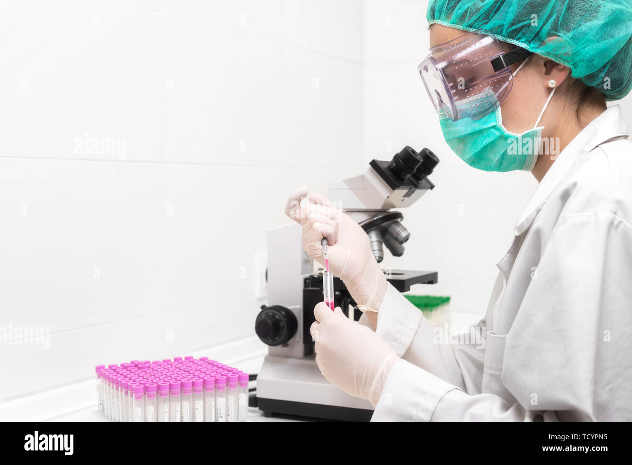 Young female scientist in modern laboratory, using microscope Stock ...