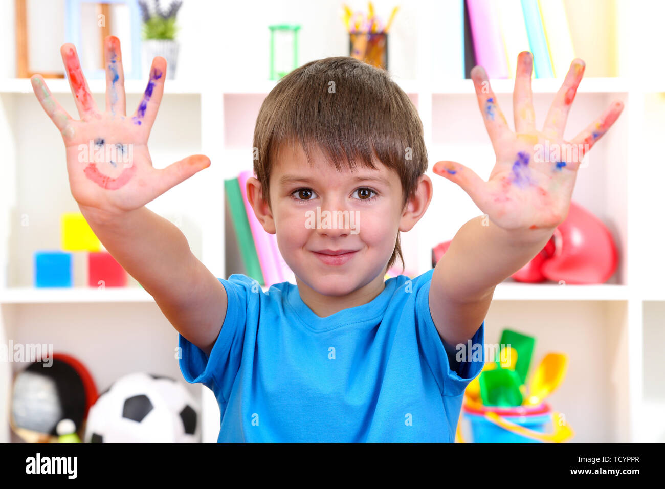Boy hands painted with colorful paint Stock Photo - Alamy