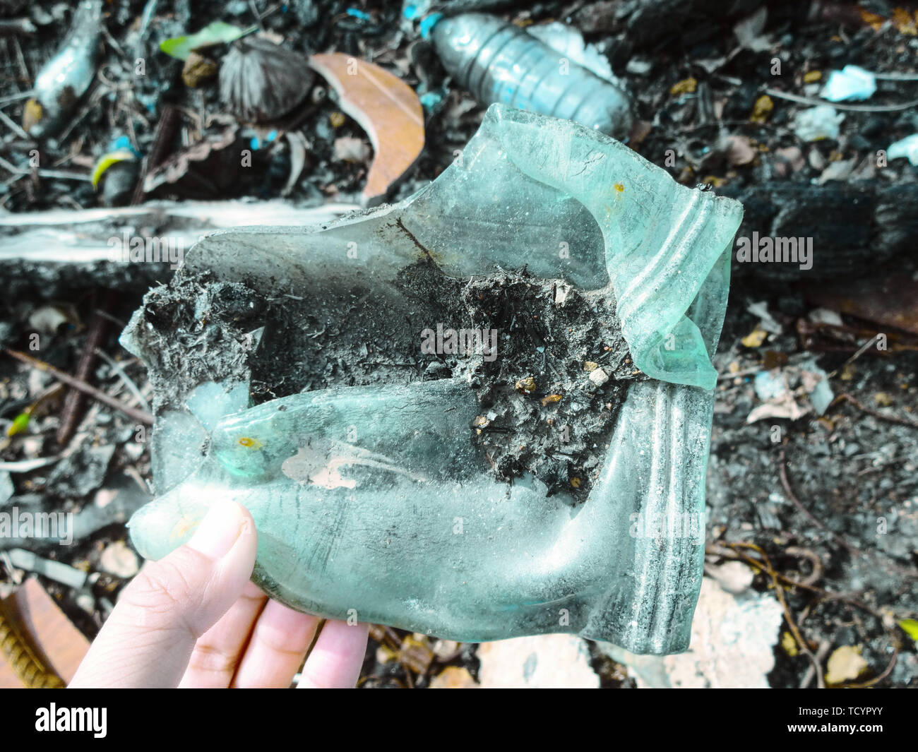 Burned, melted glass cans Stock Photo - Alamy