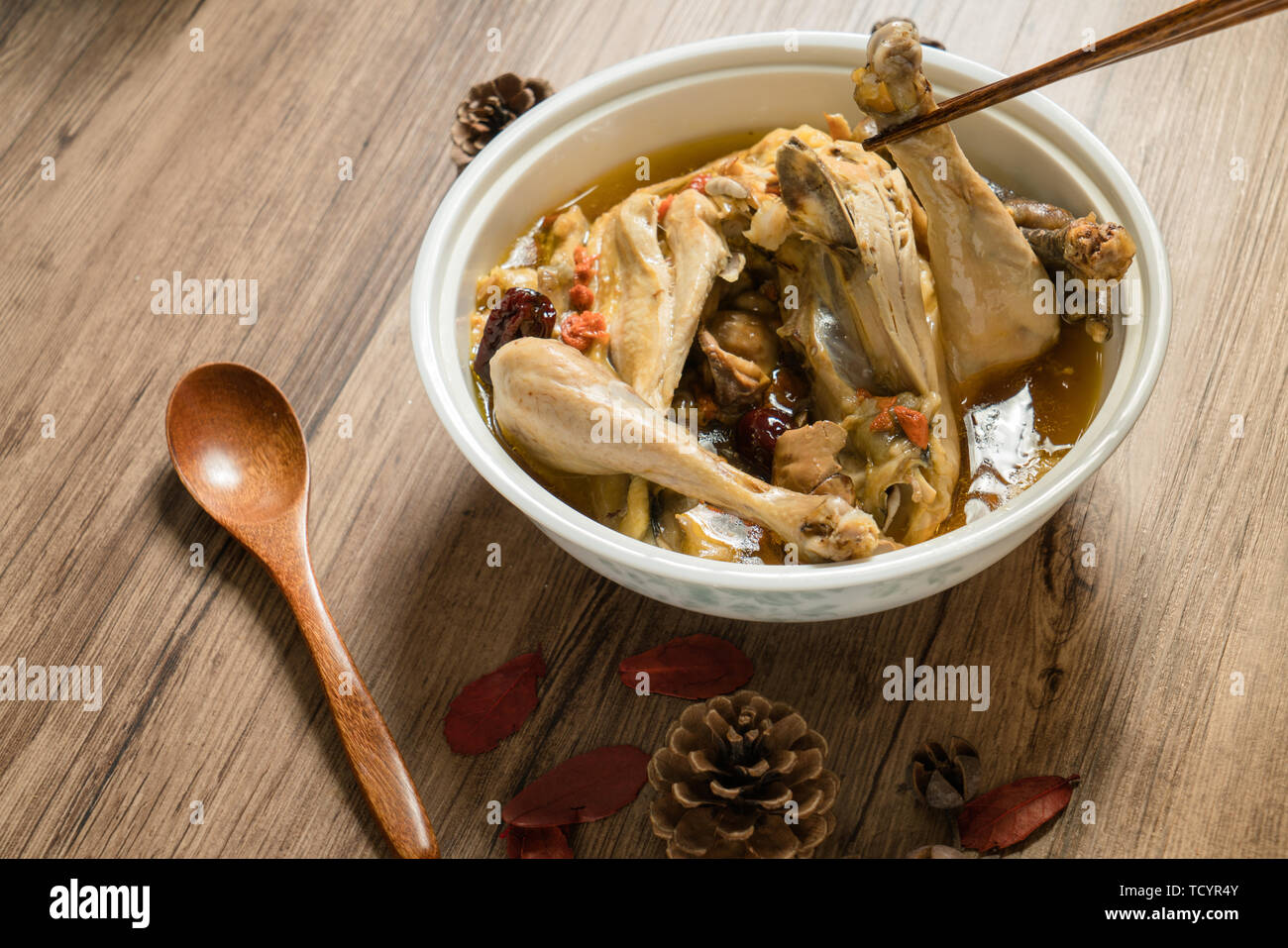 Chicken soup with wood pattern background Stock Photo - Alamy