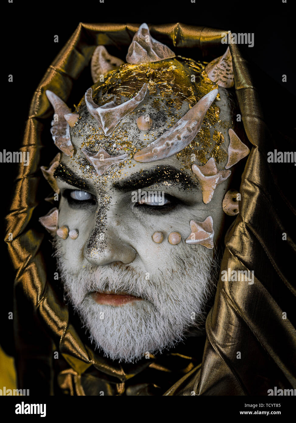Man with thorns or warts, face covered with glitters. Senior man with ...