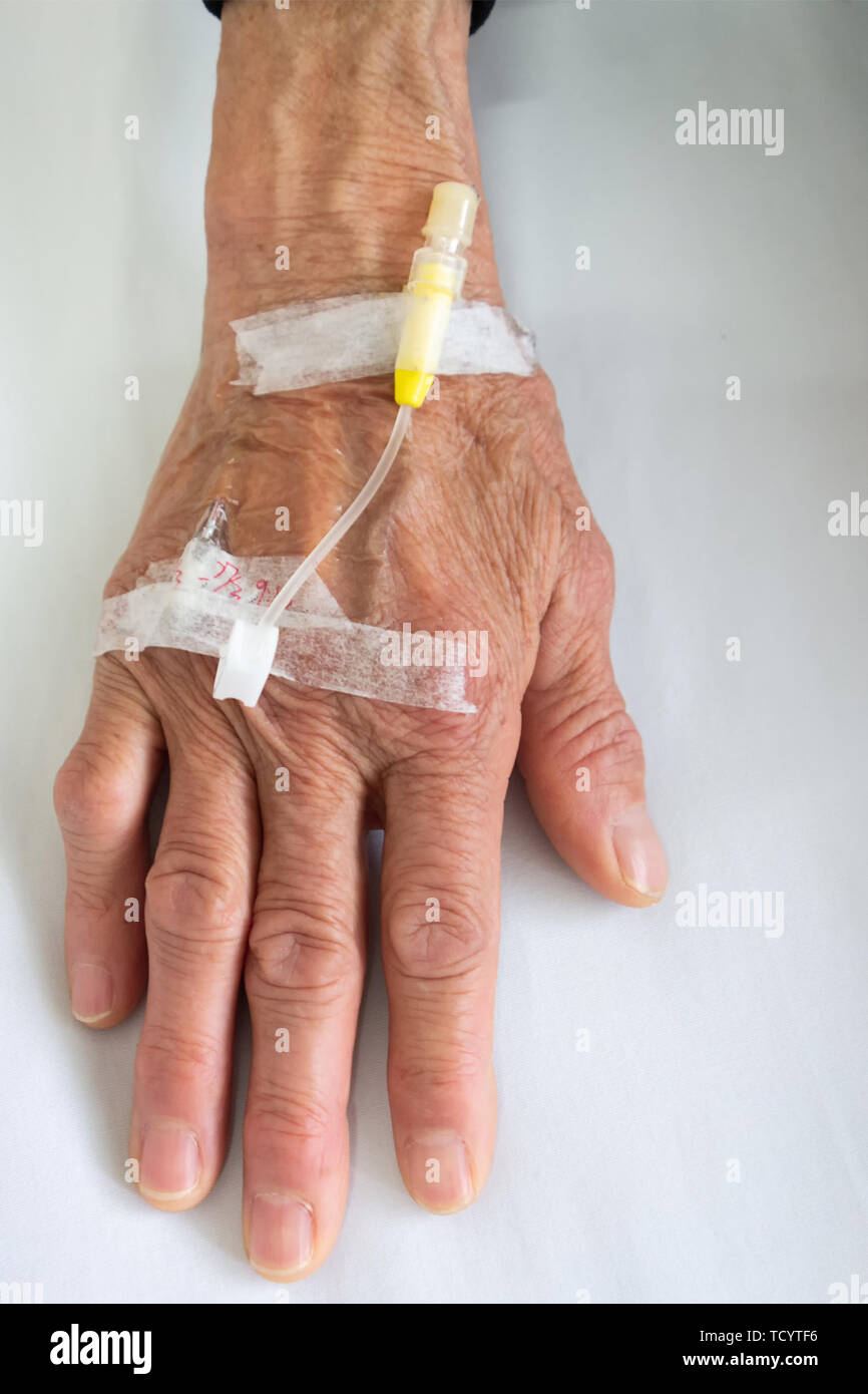 Old man's hands plugging needles Stock Photo - Alamy