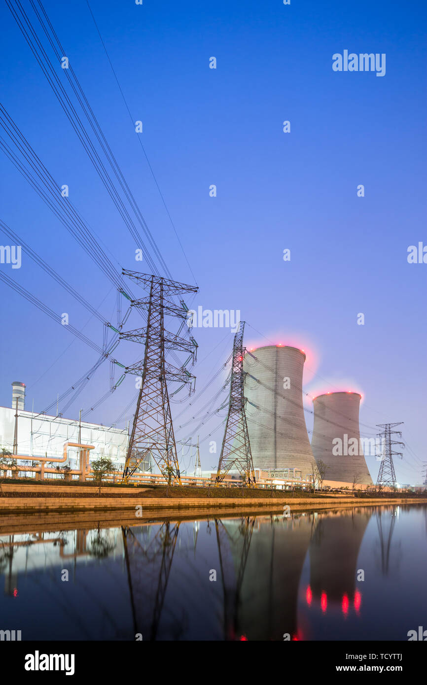 modern factory near river in blue sky at twilight Stock Photo - Alamy