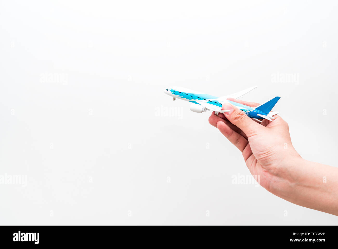 Hand-held airplane model flying concept picture on white background ...