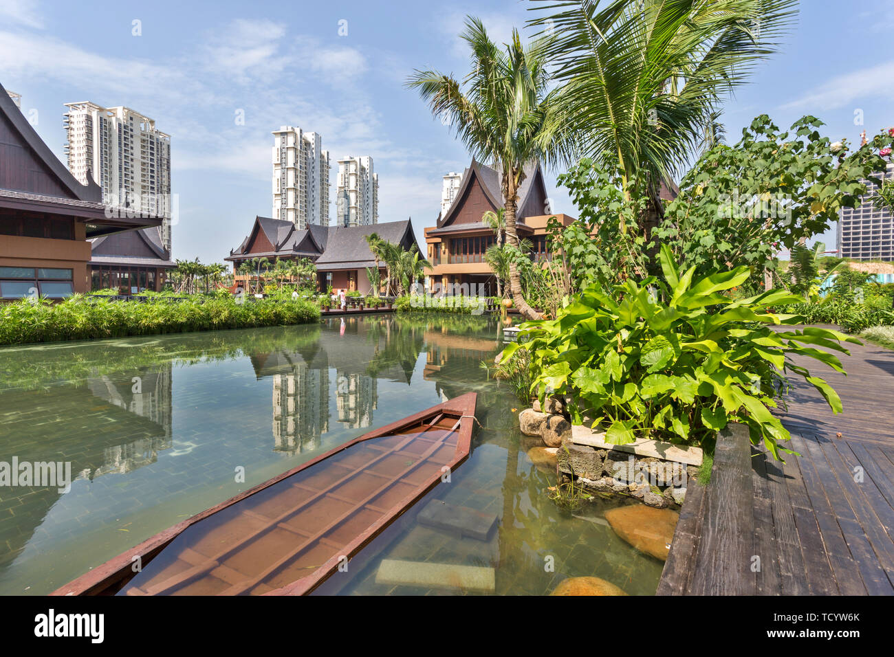 boat stop in water with resort building exterior Stock Photo - Alamy