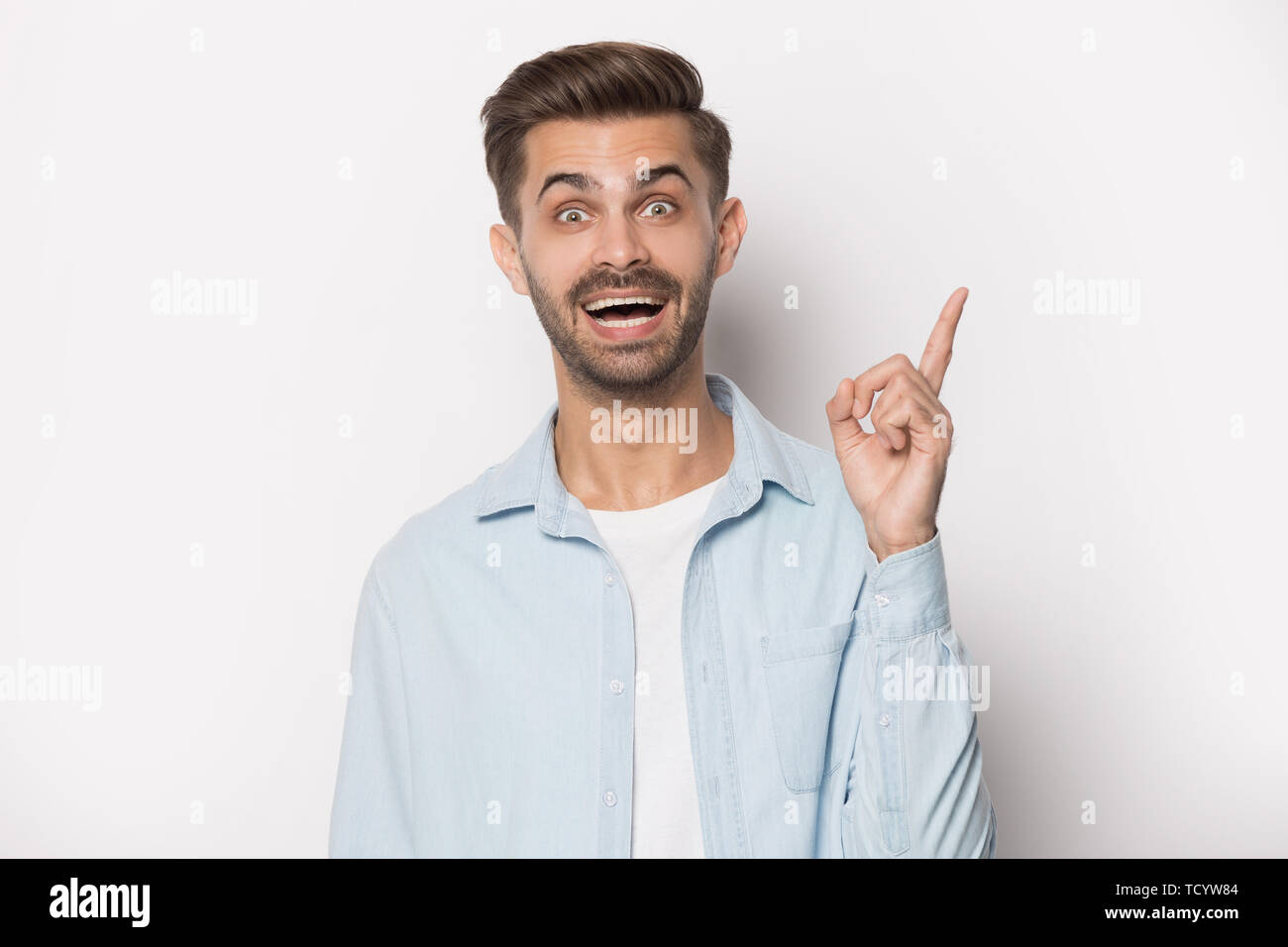 Guy raised finger up gesture of resourceful person studio shot Stock ...