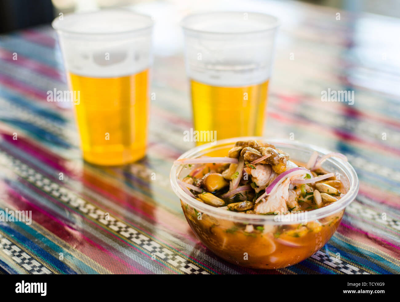 Peruvian mixed ceviche with red onion and fried corn at a street food ...
