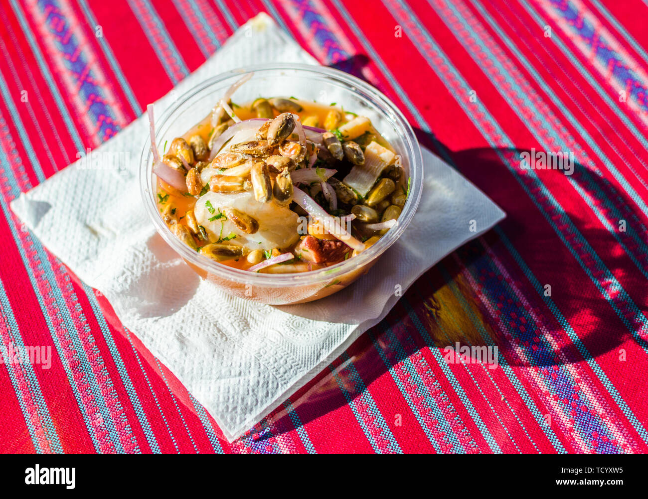 Peruvian mixed ceviche with red onion and fried corn at a street food ...