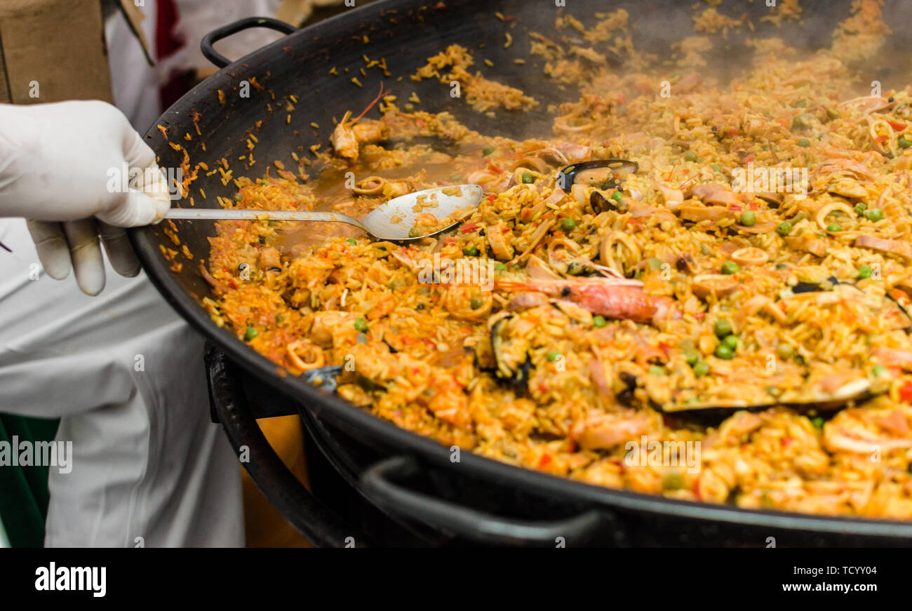 Seafood paella in a paella pan at a street food market Stock Photo - Alamy