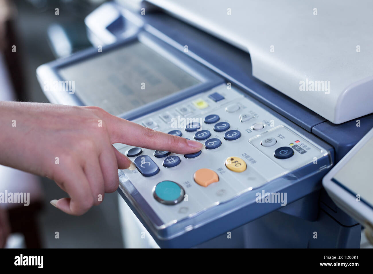 Hand press button on panel of printer Stock Photo - Alamy