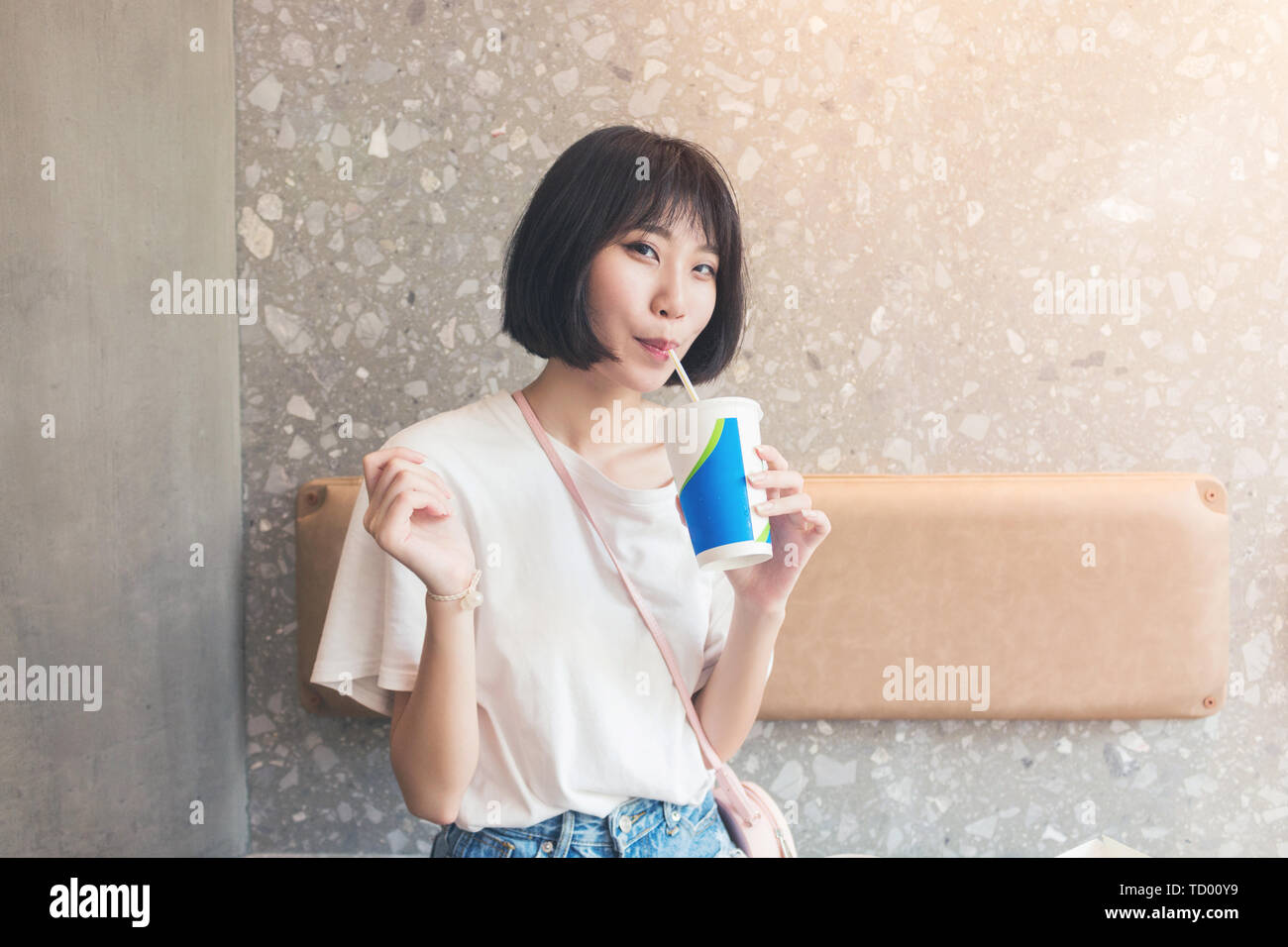 Happy girl drinking coke in the restaurant Stock Photo - Alamy
