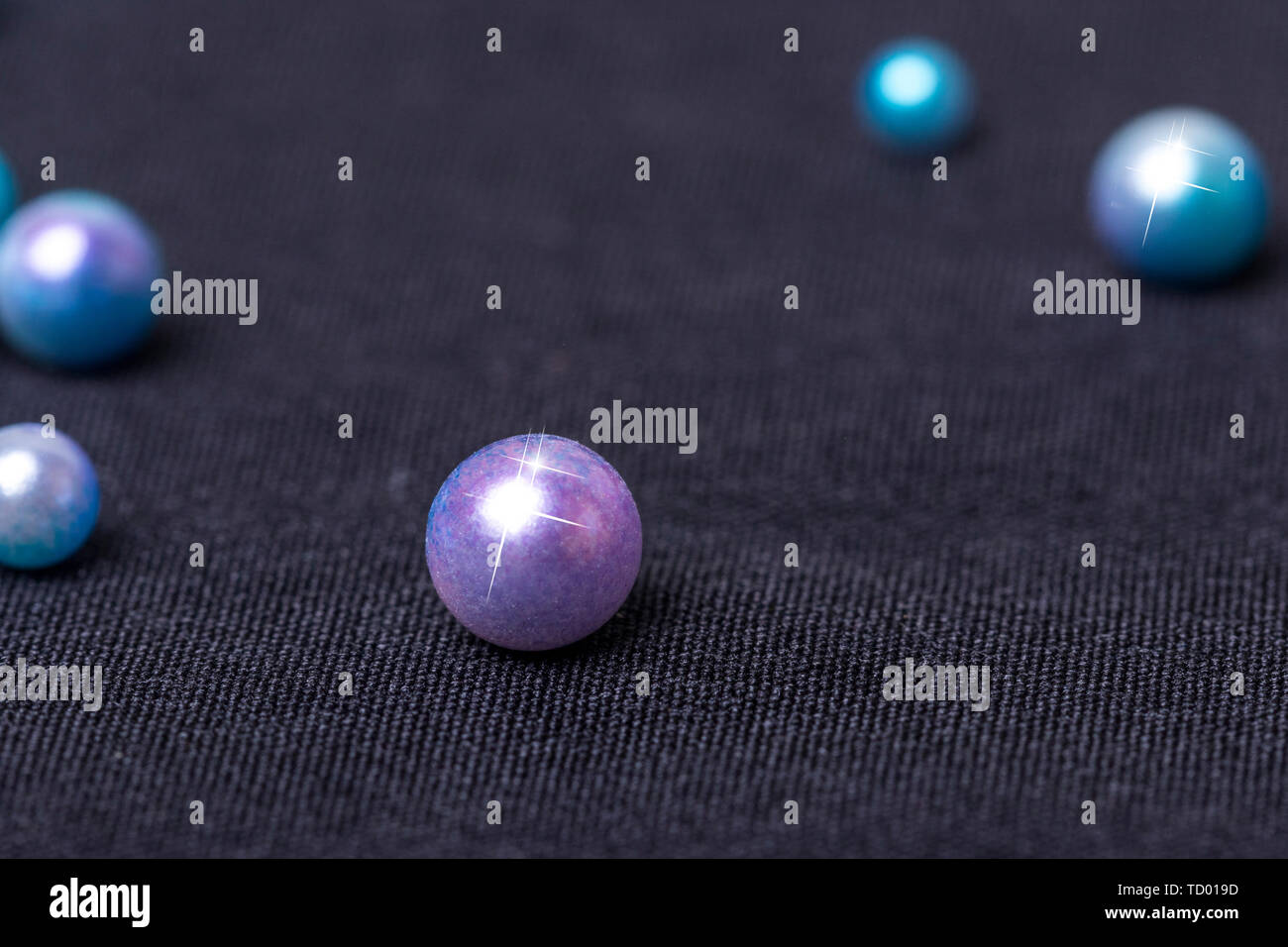Colorful pearls on black background Stock Photo - Alamy