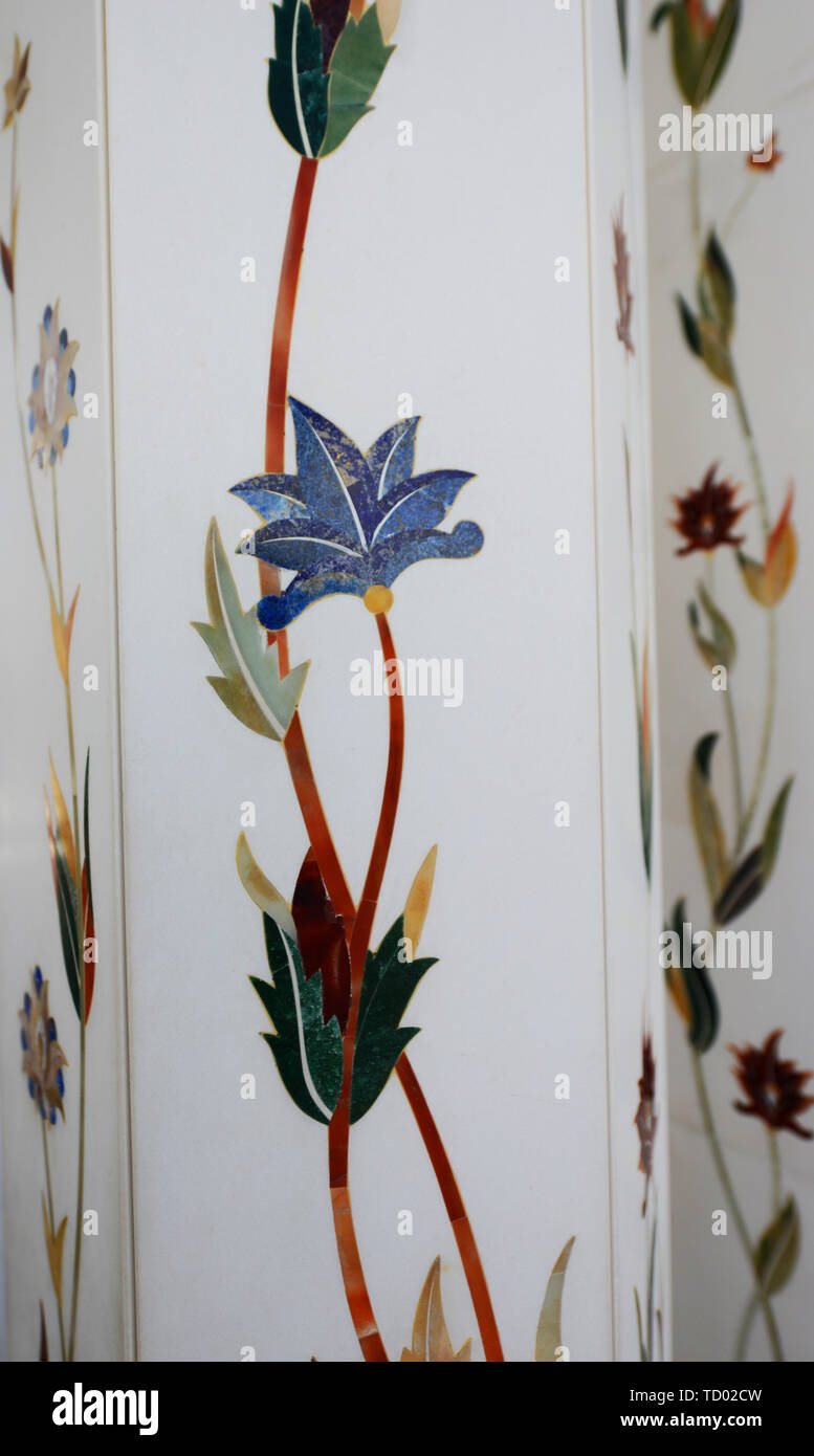 A wall decorated with flowers made of colored marble inside the new ...