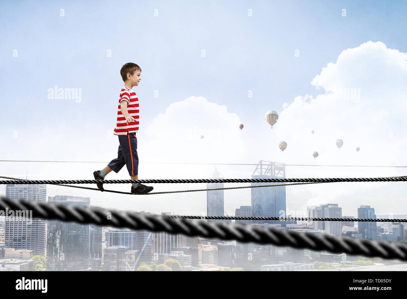 Cute joyful little boy walking on a rope over city. Mixed media Stock ...
