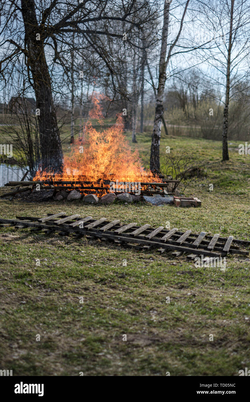 open fire burning in countryside home garden. controlled pyromaniac ...