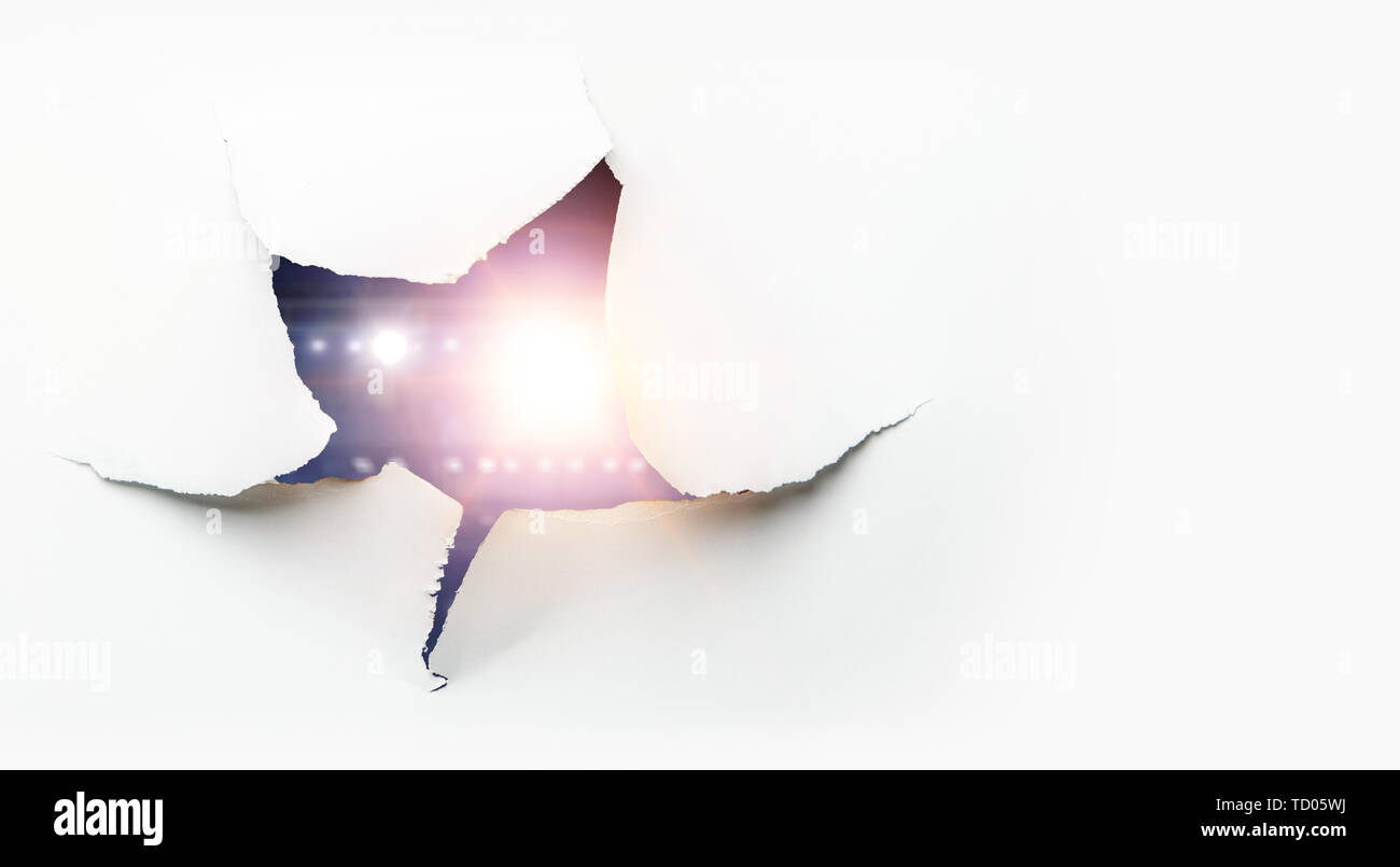 Paper torn hole effect with stadium view Stock Photo - Alamy