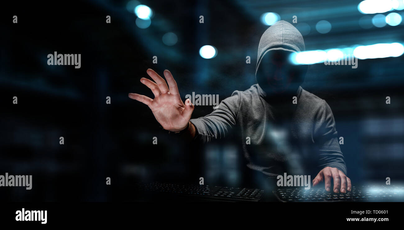 Hacker in hoodie dark theme Stock Photo - Alamy