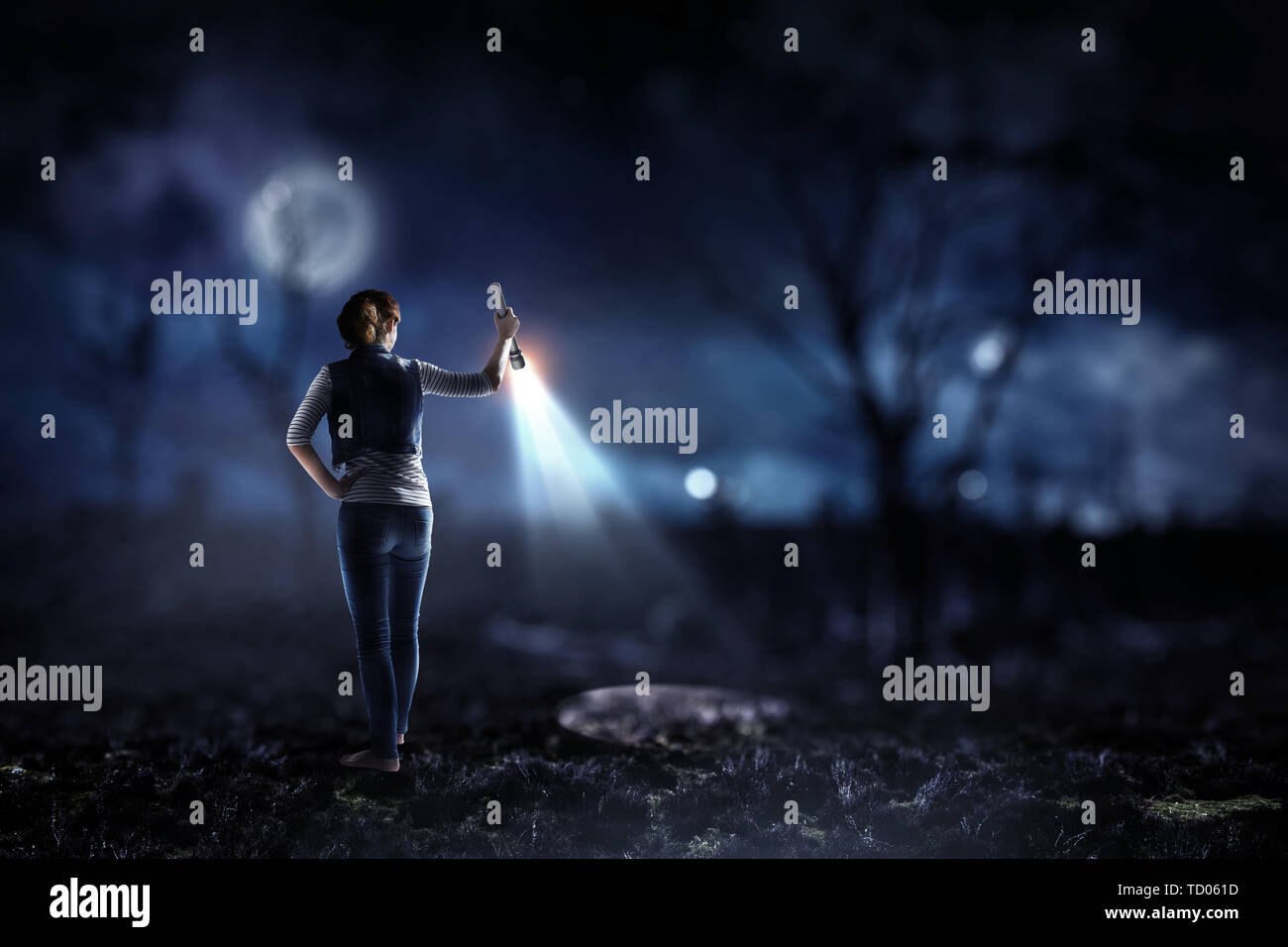 Woman flashlight trees hi-res stock photography and images - Alamy