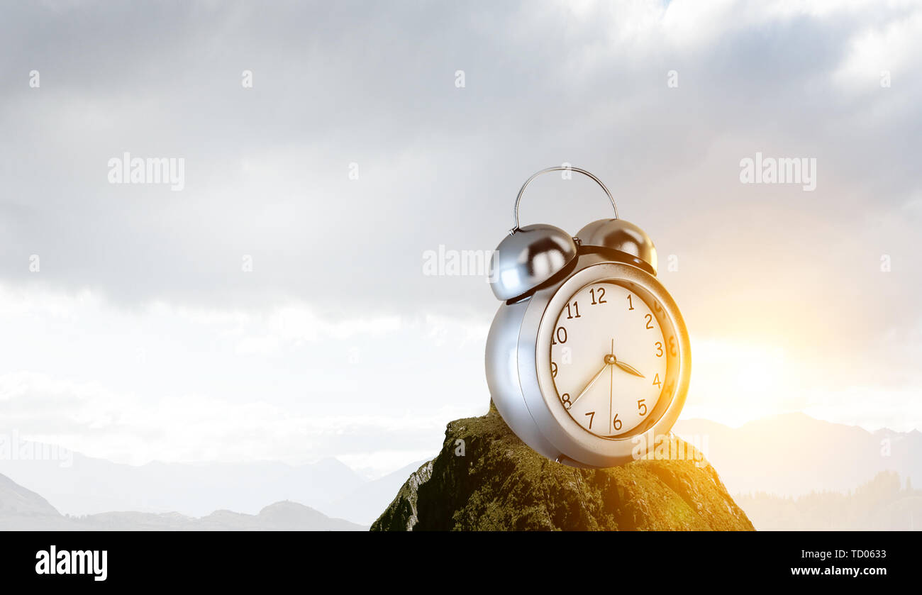 Clock on the ground with mountain landscape view Stock Photo - Alamy