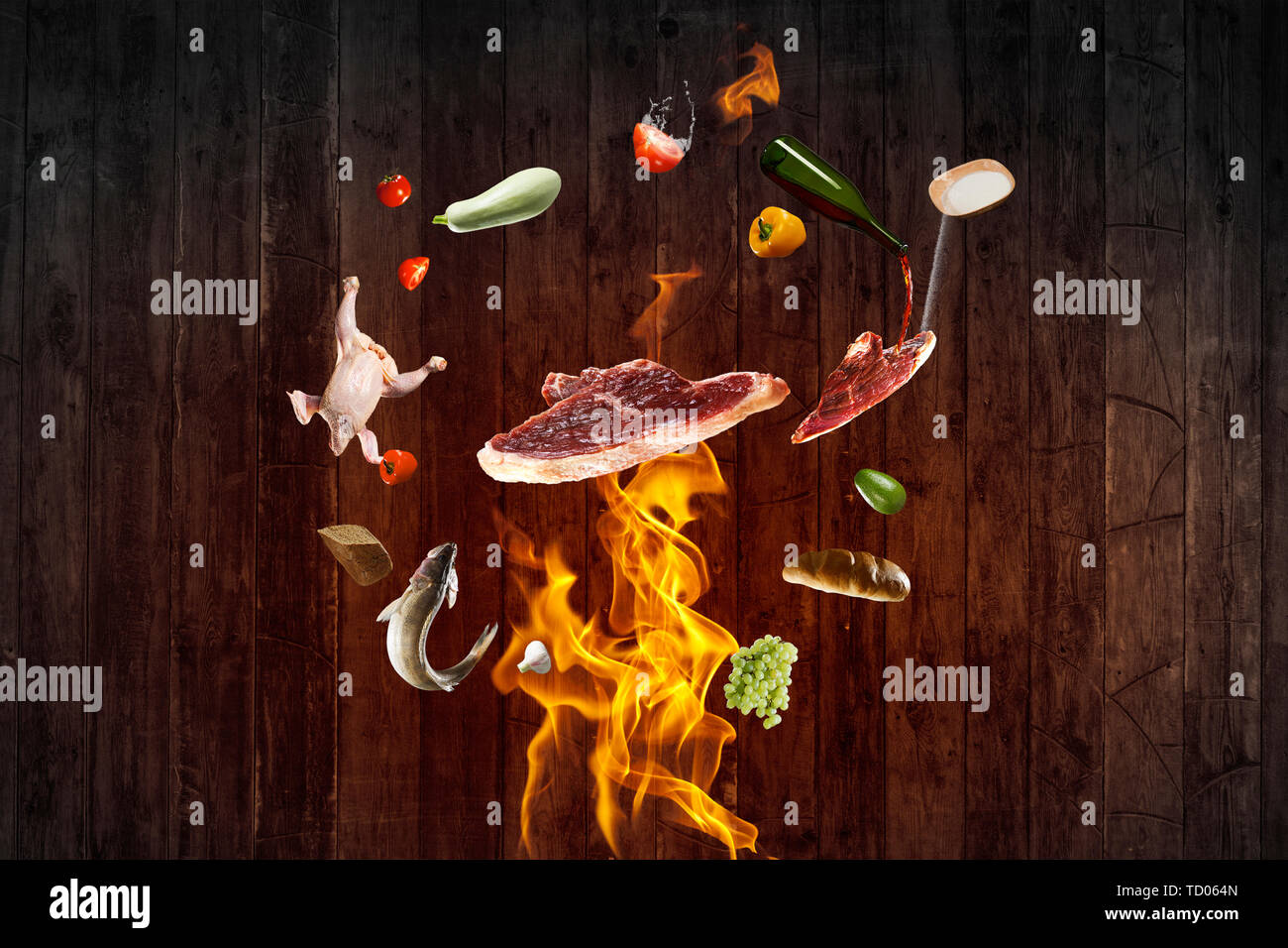 Food Ingredients flying around fire Stock Photo - Alamy