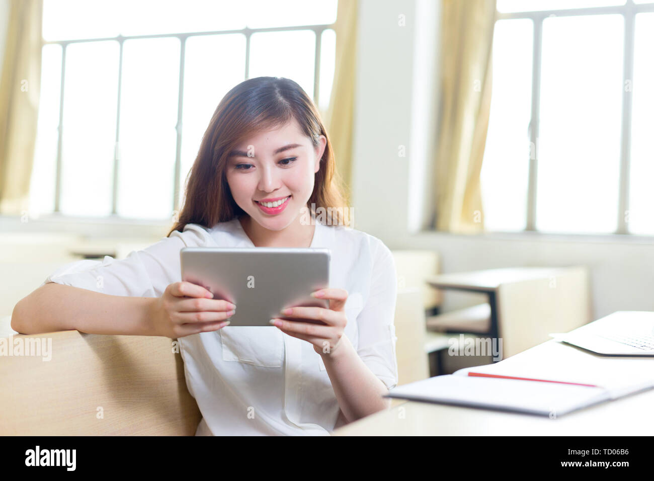 young beautiful asian girl student with tablet in classroom Stock Photo ...