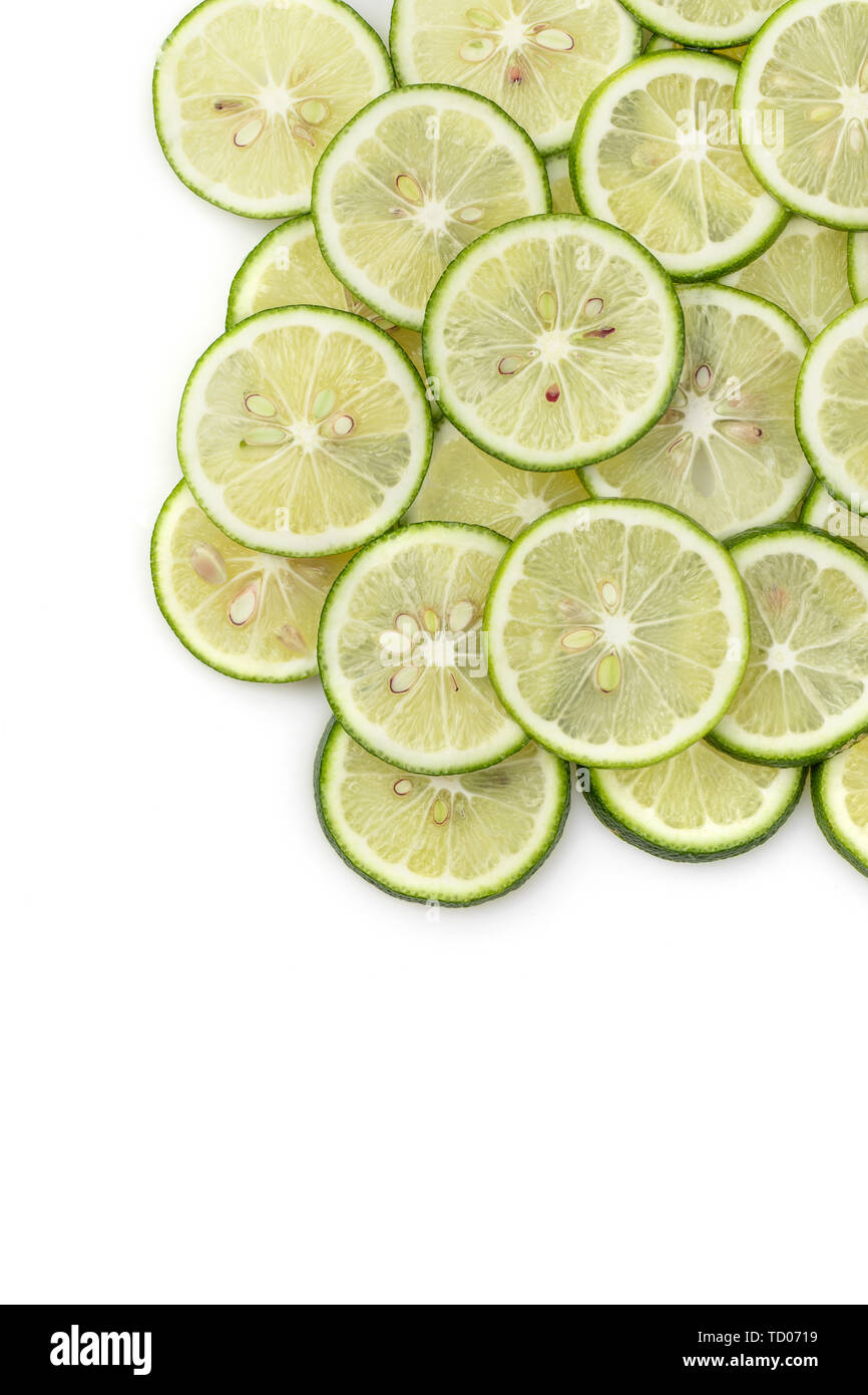 Green lemon slices on white background Stock Photo - Alamy