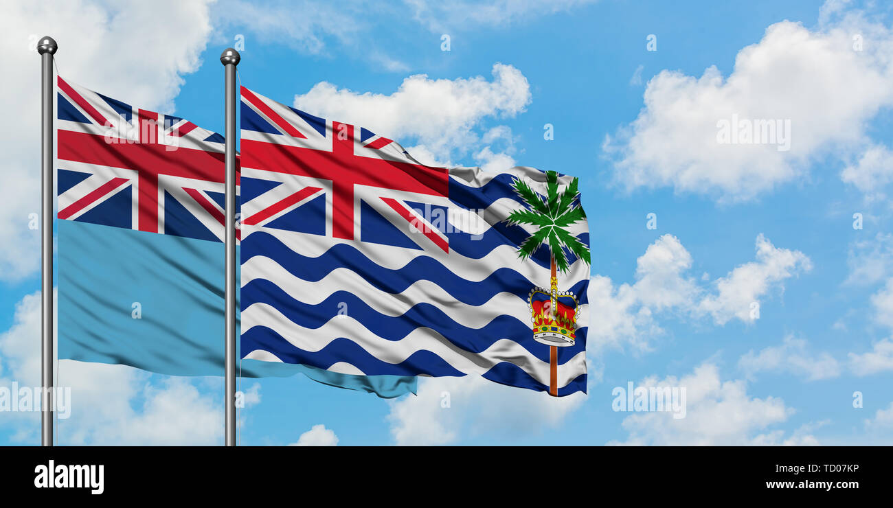Fiji and British Indian Ocean Territory flag waving in the wind against ...