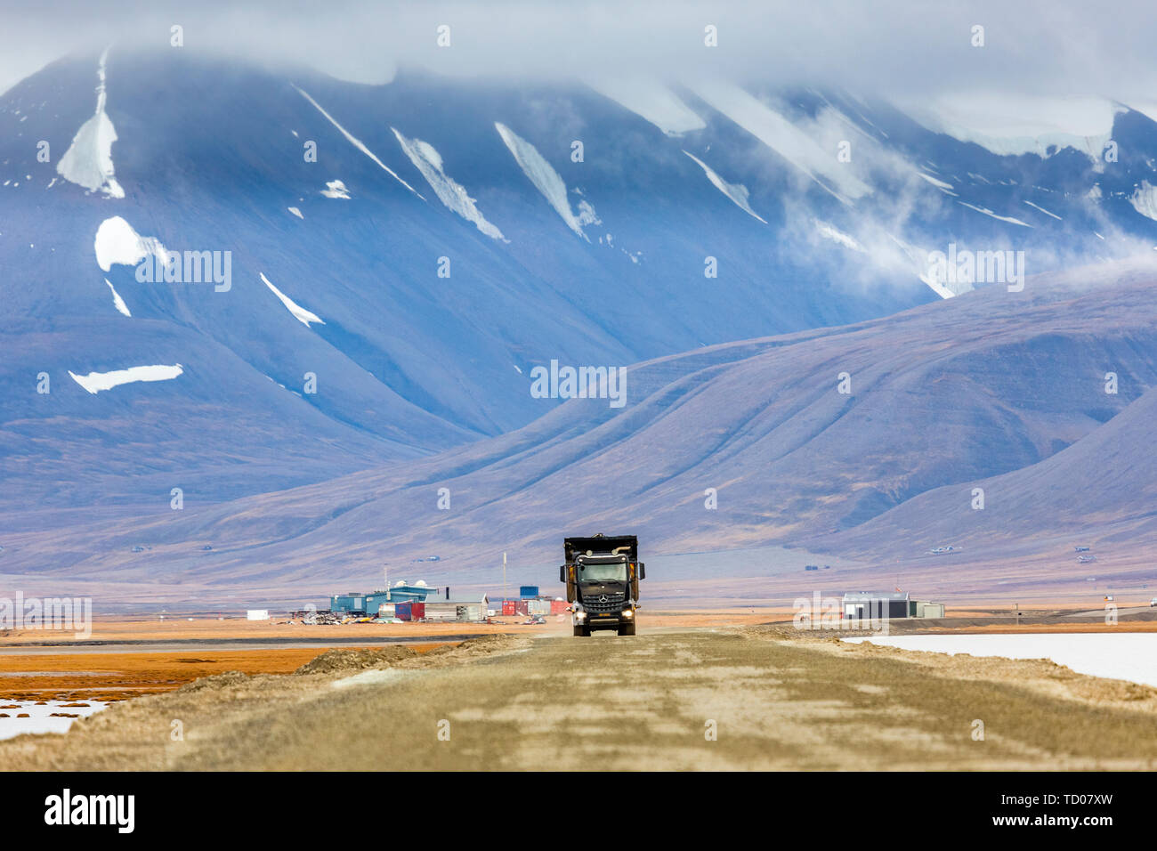 Inside adventdalen fjord - Truck carry coal from mine Number 7 - clouds ...