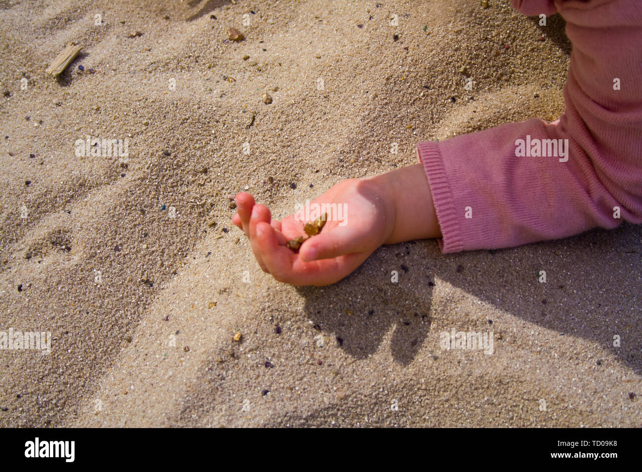 Child hands through sand hi-res stock photography and images - Alamy
